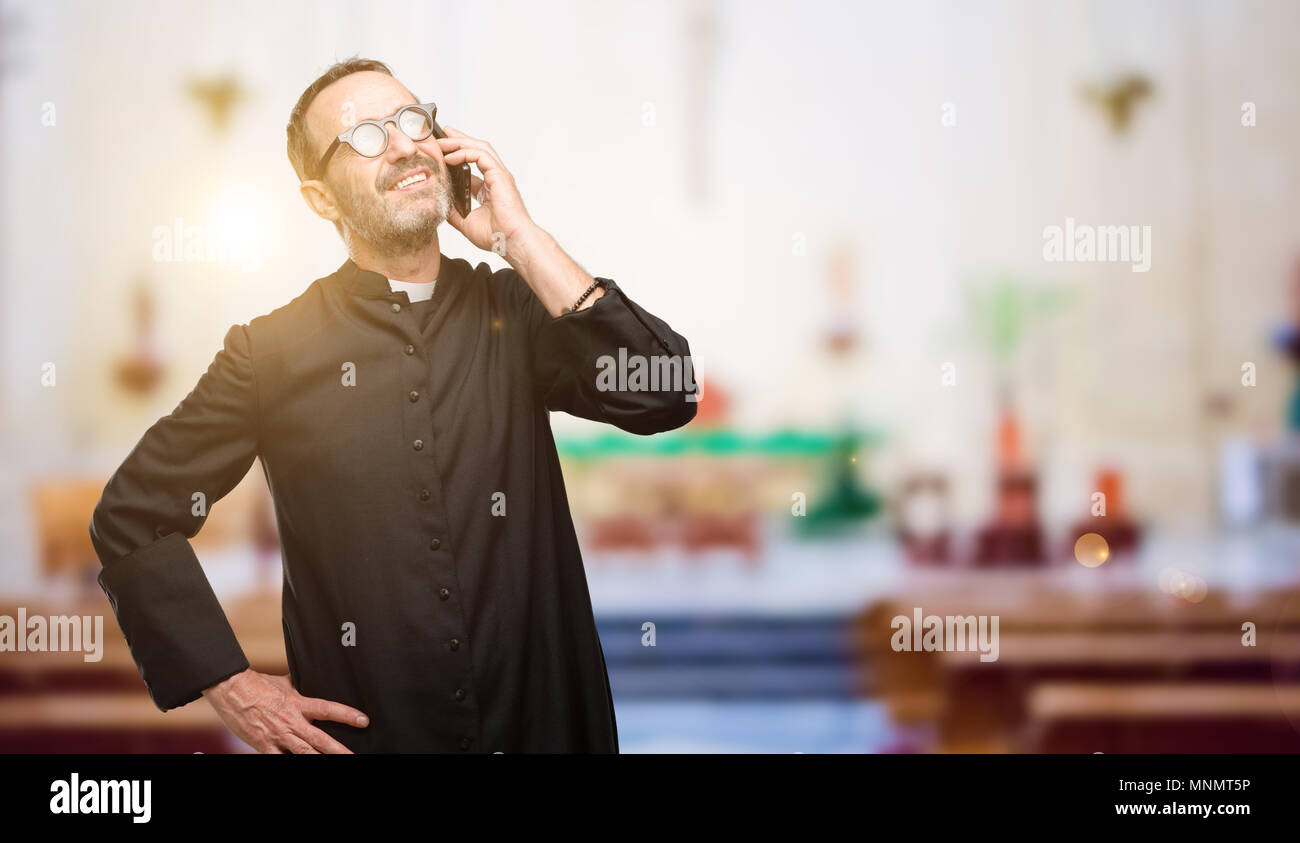 Priest religion man happy talking using a smartphone mobile phone at ...