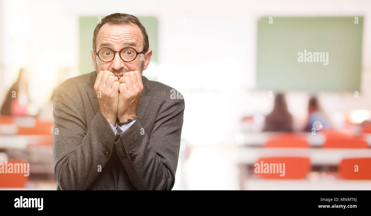 Teacher man using glasses terrified and nervous expressing anxiety and ...