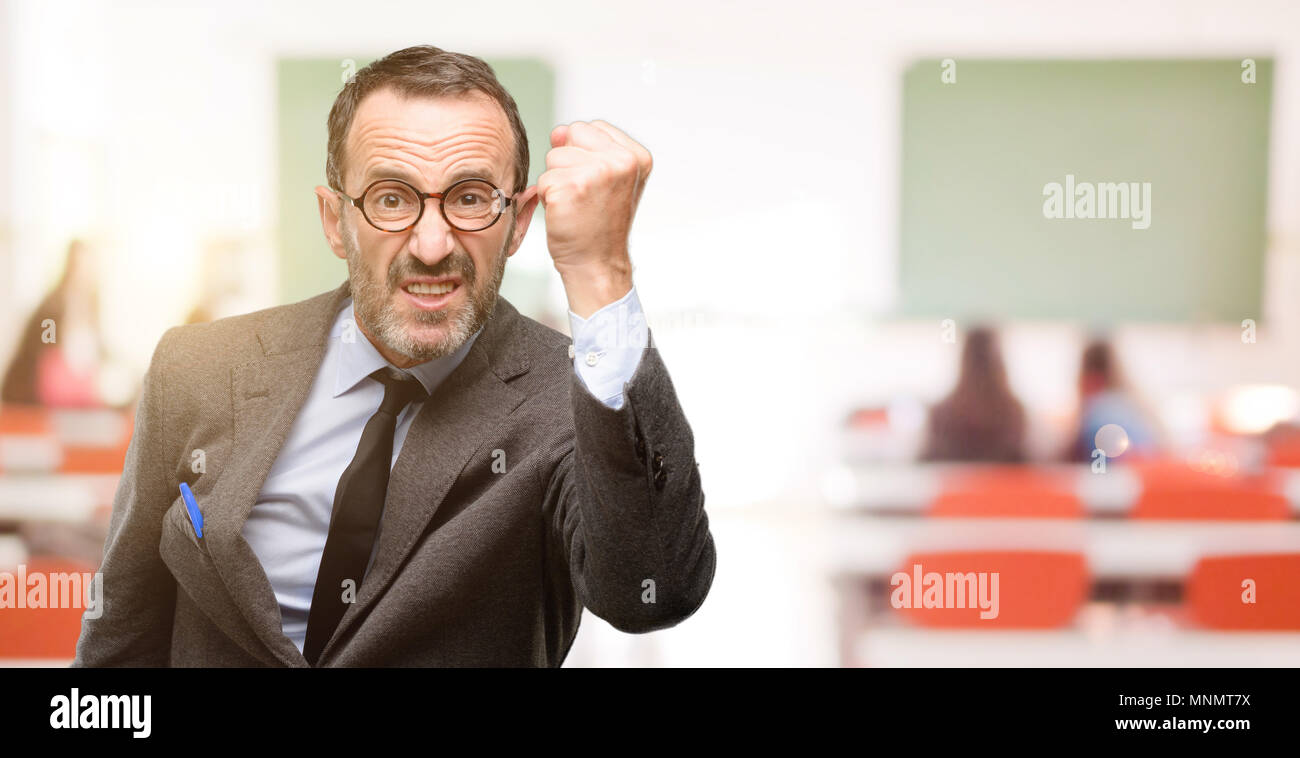 Teacher man using glasses irritated and angry expressing negative ...