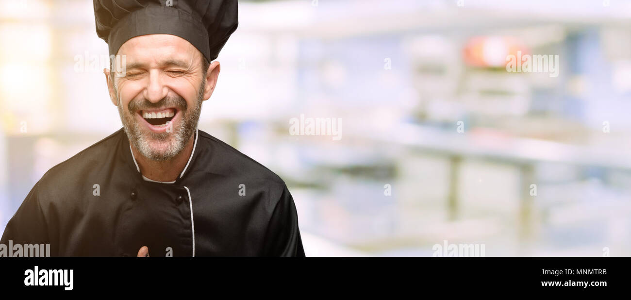 Senior cook man, wearing chef hat confident and happy with a big ...