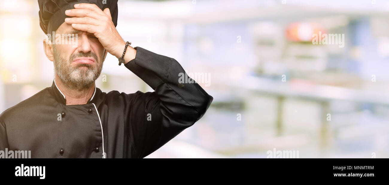 Senior cook man, wearing chef hat terrified and nervous expressing ...