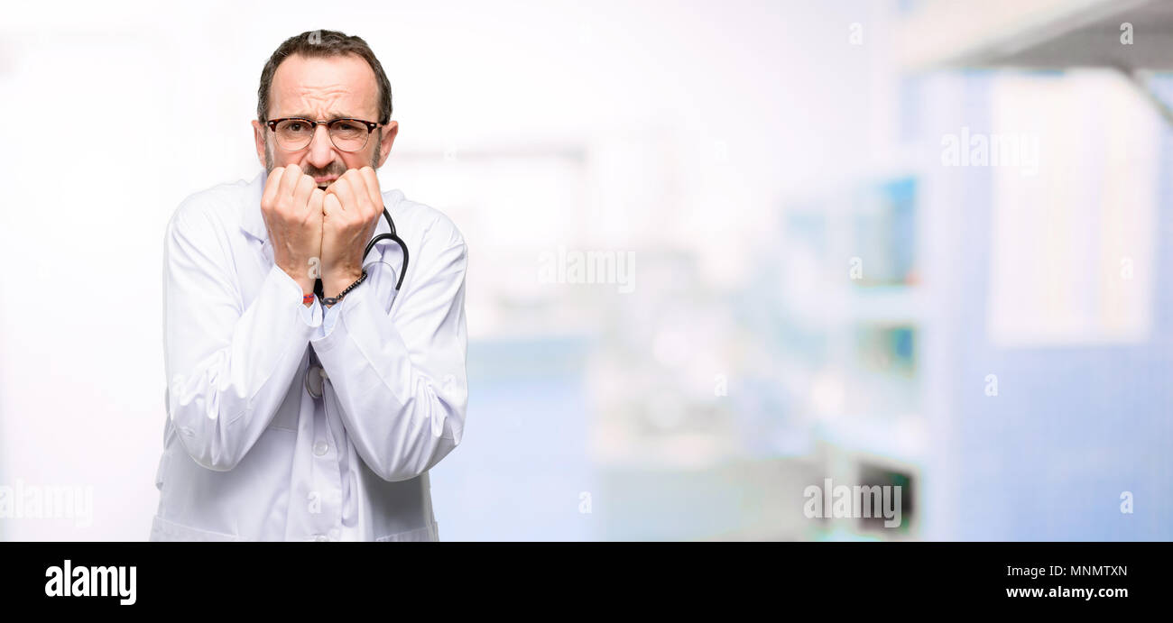 Doctor senior man, medical professional terrified and nervous ...