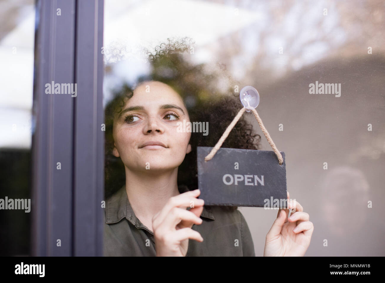 Small business owner opening store Stock Photo - Alamy