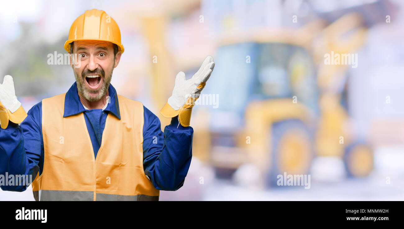 Senior engineer man, construction worker happy and surprised cheering ...
