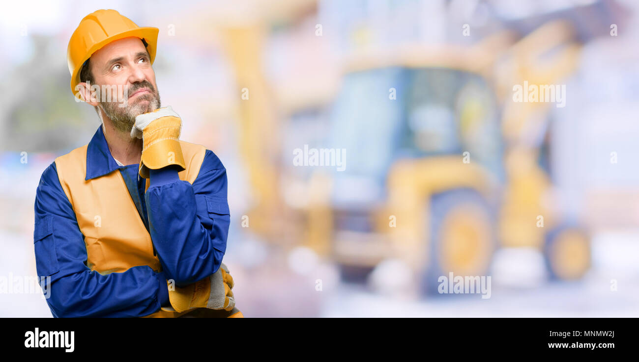 Senior engineer man, construction worker thinking and looking up ...