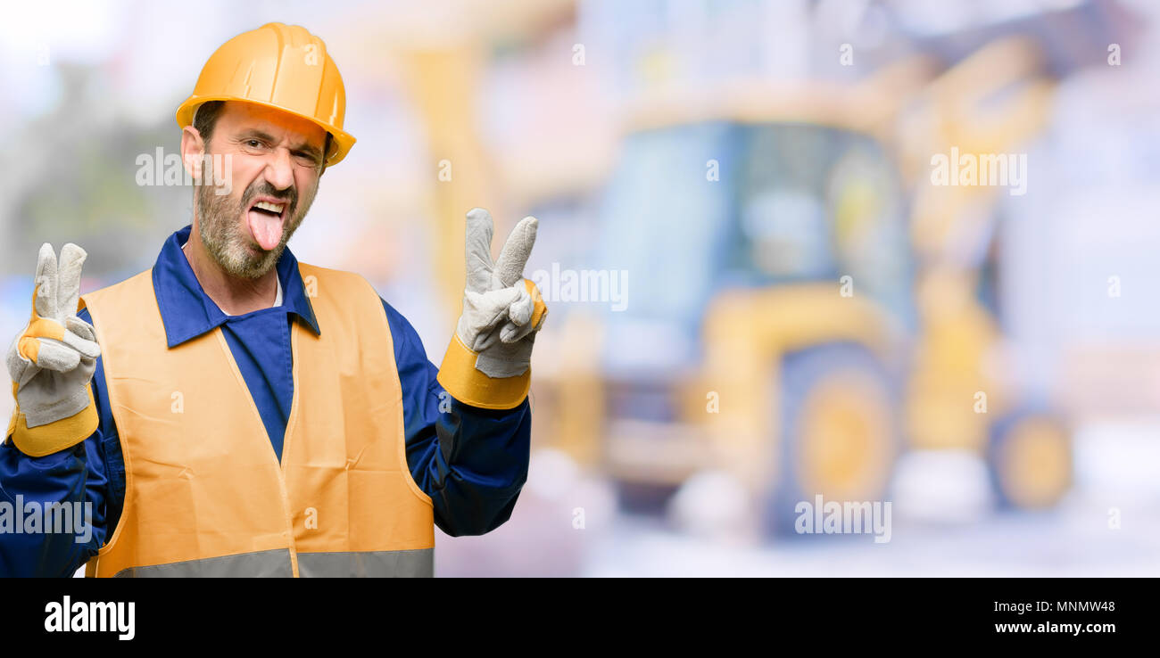 Senior engineer man, construction worker looking at camera showing tong ...