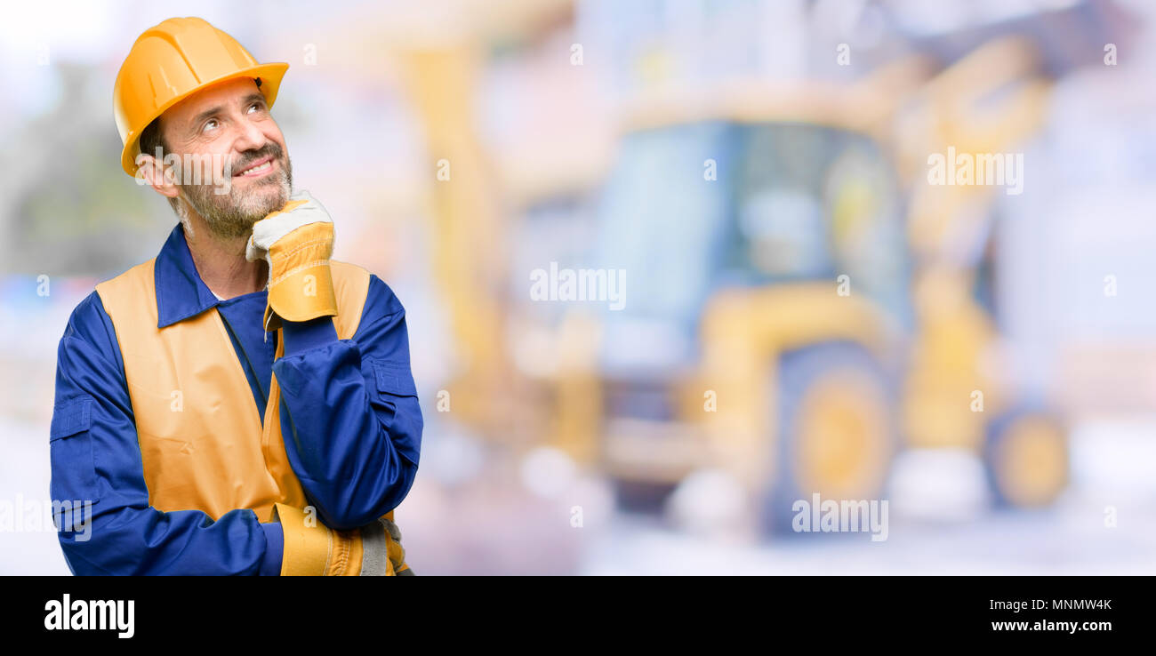 Senior engineer man, construction worker thinking and looking up ...