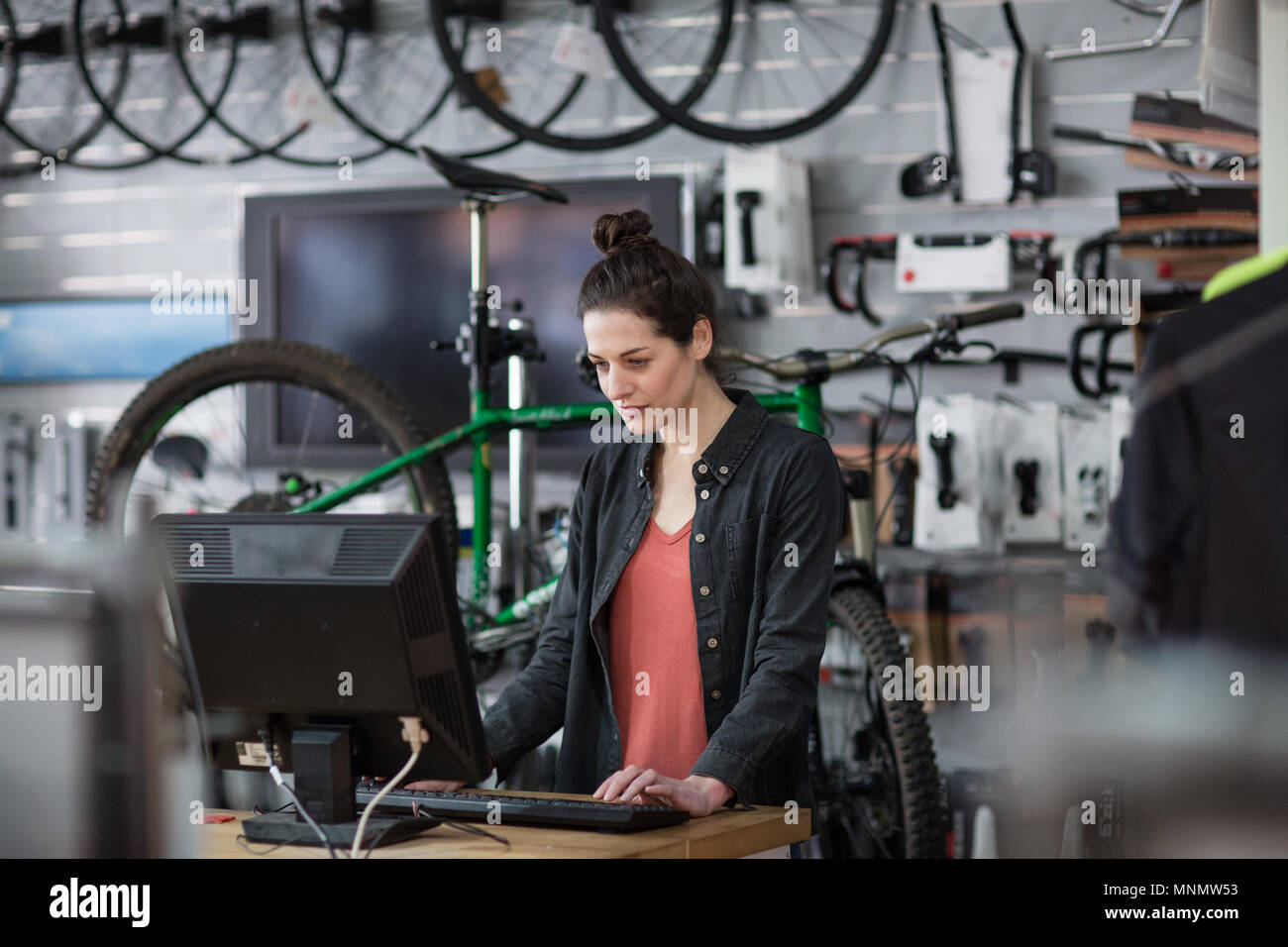 Small business owner using computer in a store Stock Photo - Alamy