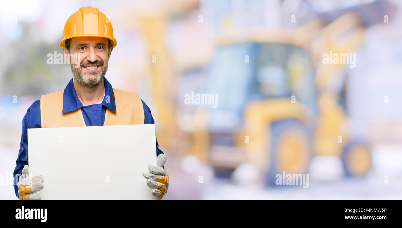 Senior engineer man, construction worker holding blank advertising ...