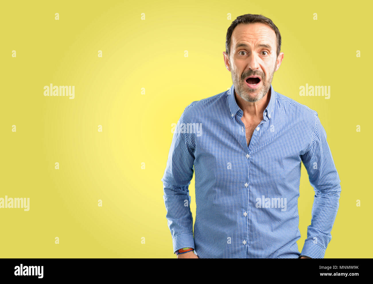 Handsome middle age man scared in shock, expressing panic and fear ...