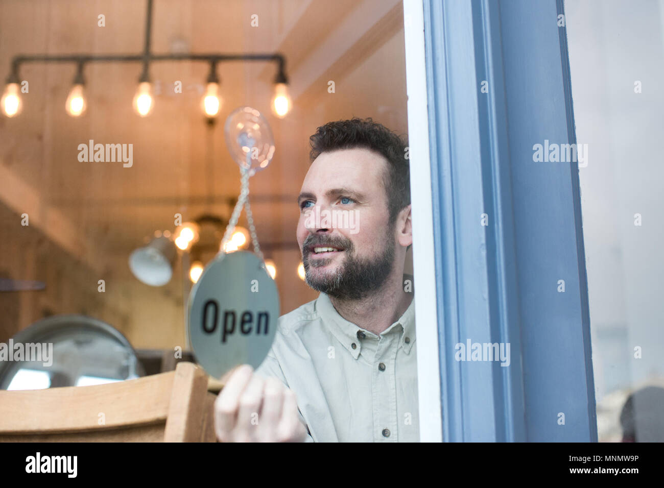 Small business owner opening store Stock Photo - Alamy