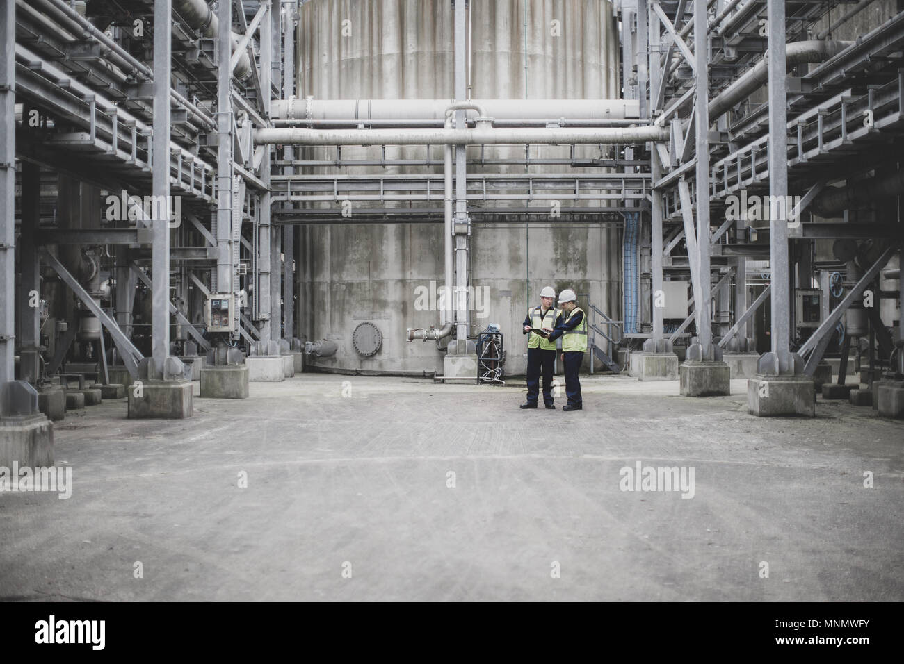 Industrial workers using a digital tablet on site Stock Photo - Alamy
