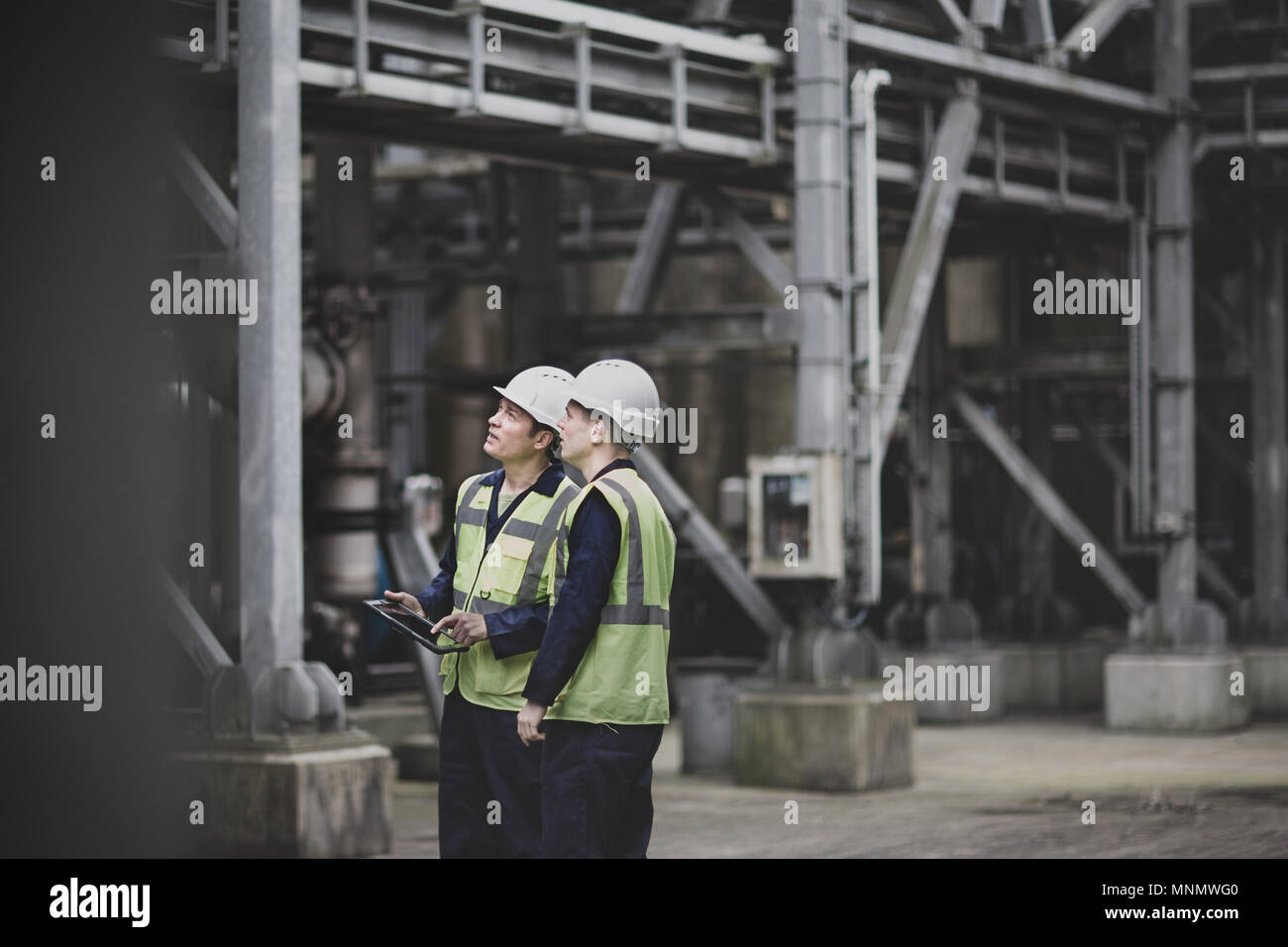 Industrial workers using a digital tablet on site Stock Photo - Alamy
