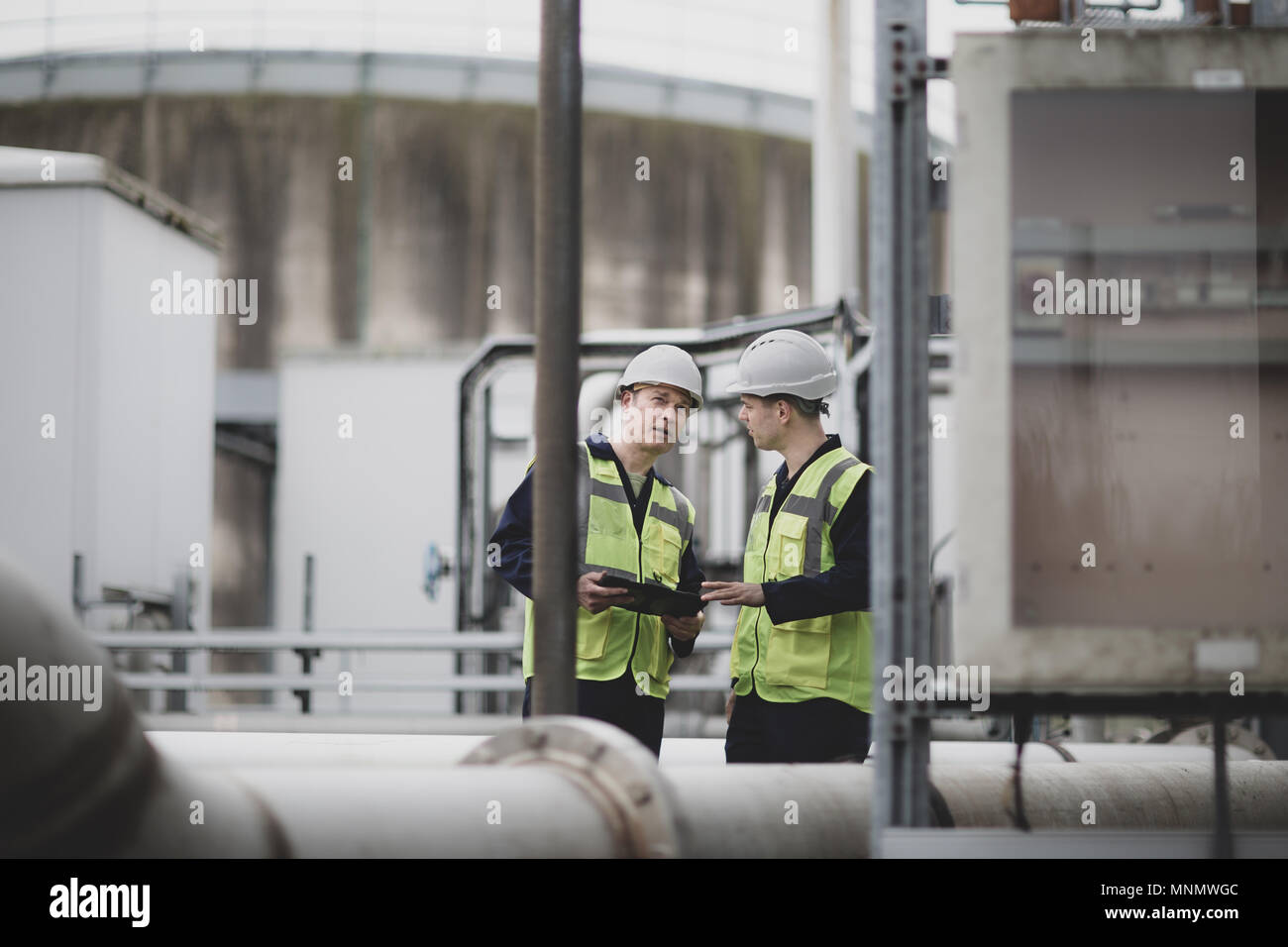 Industrial workers using a digital tablet on site Stock Photo - Alamy