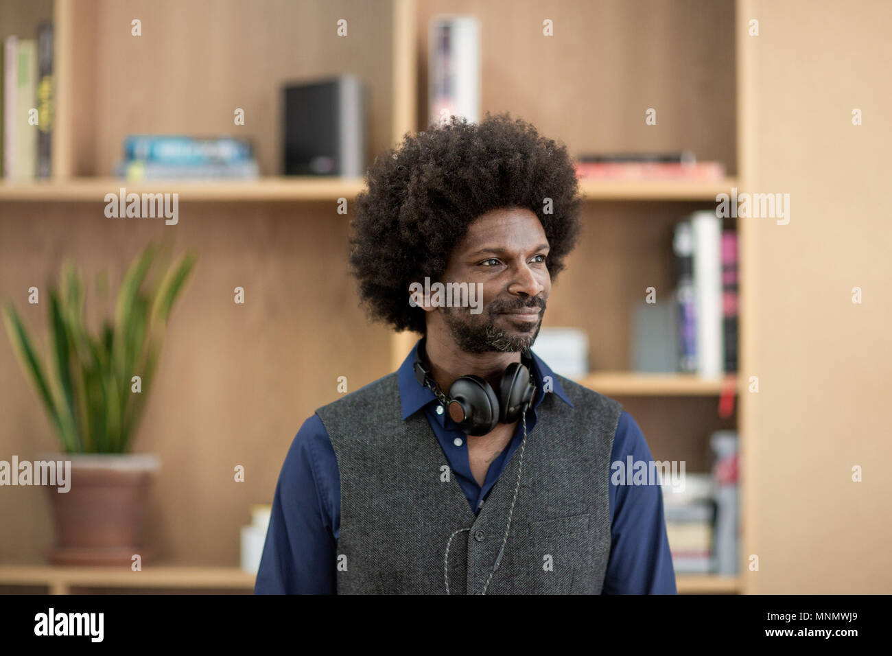 Businessman looking out window thinking Stock Photo - Alamy