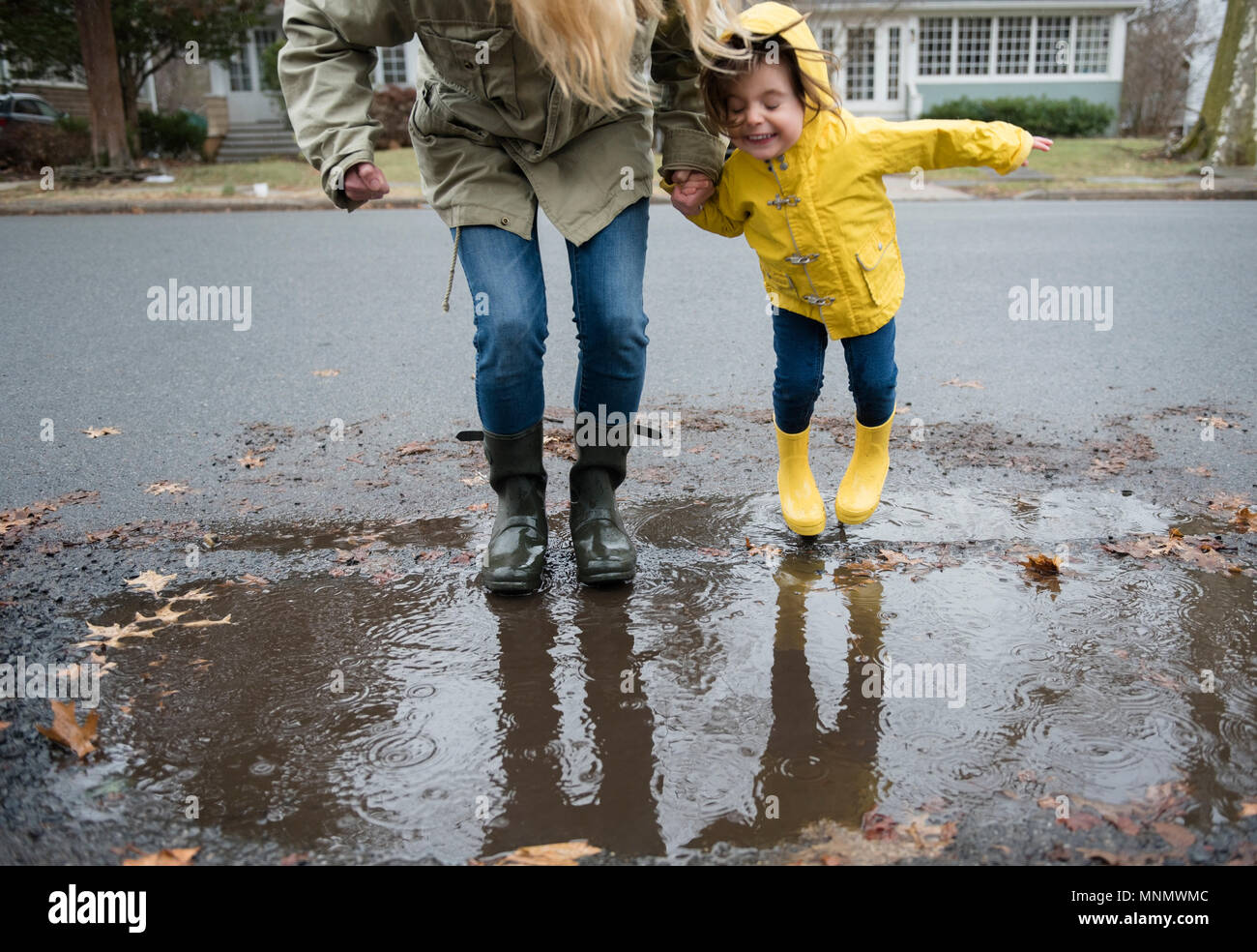 Child puddle parent hi-res stock photography and images - Alamy