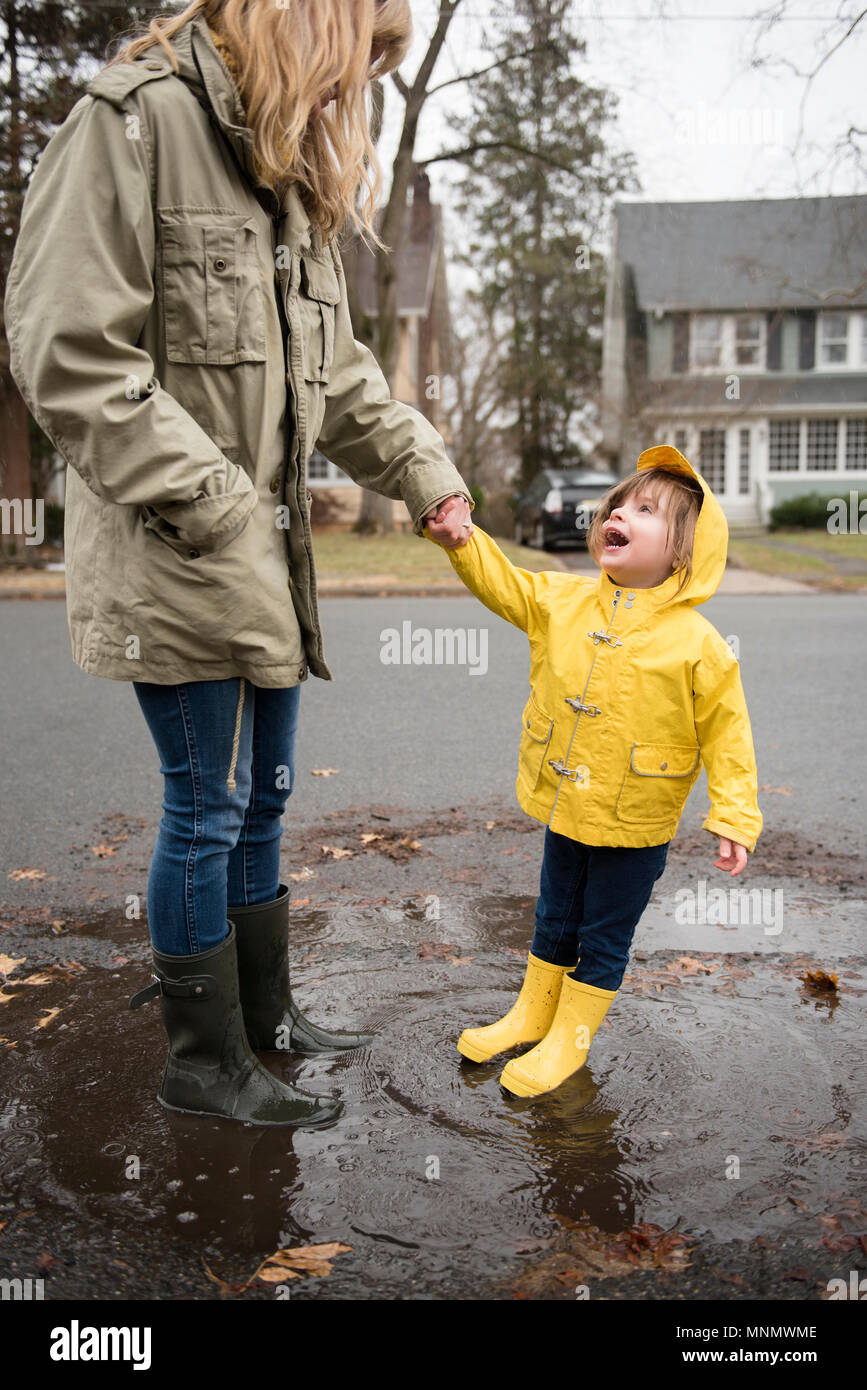 Mother and daughter (2-3) in puddle Stock Photo - Alamy
