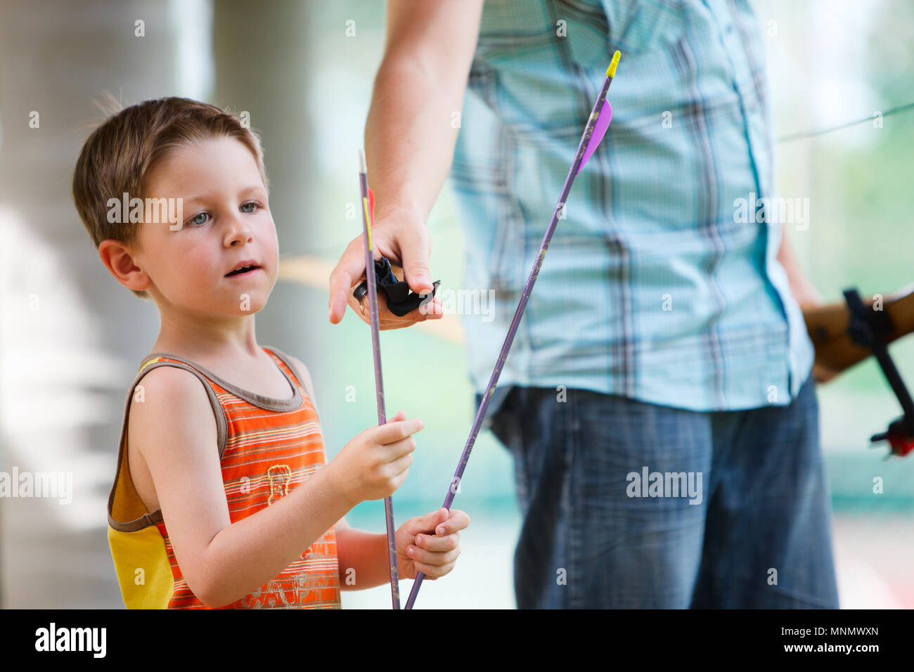 Closeup portrait of father and son with archery arrows Stock Photo - Alamy