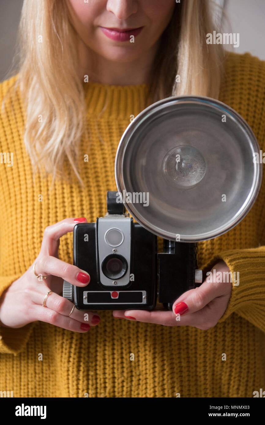Woman holding old camera Stock Photo - Alamy