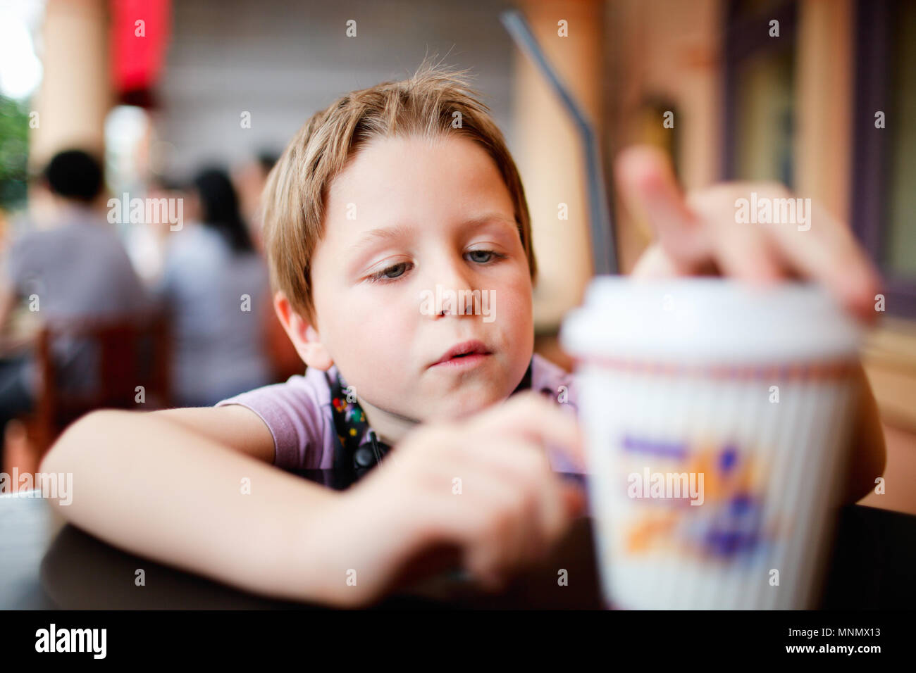 Casual portrait of little boy in cafe Stock Photo - Alamy