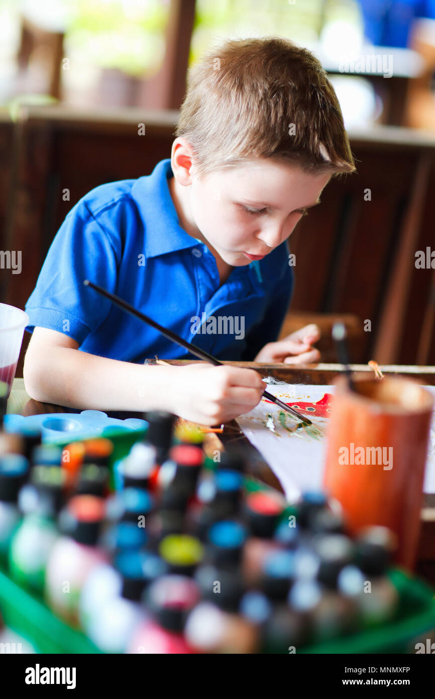 Cute little boy painting a batik Stock Photo - Alamy