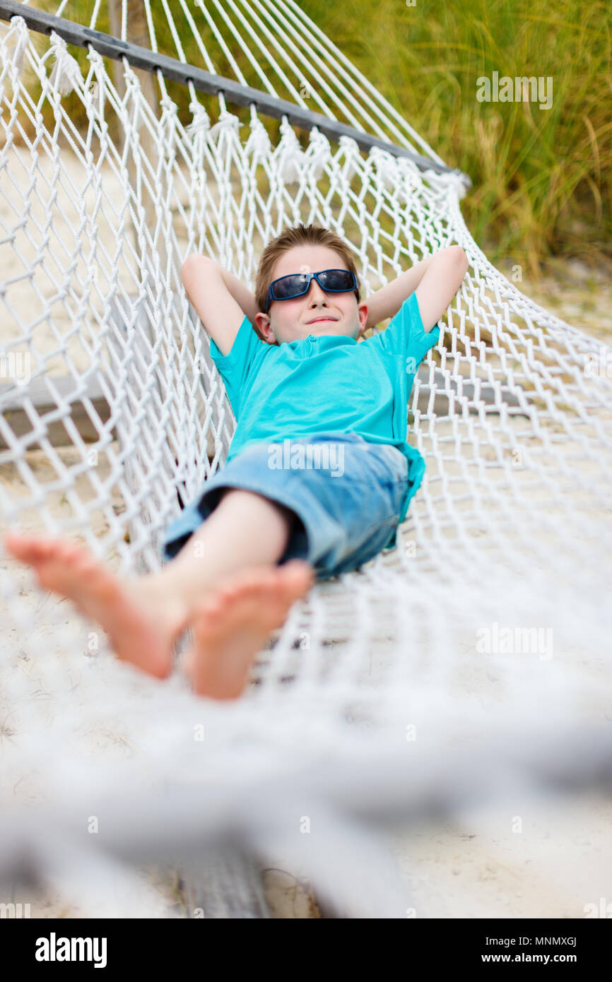 Cute smiling boy relaxing in hammock Stock Photo - Alamy