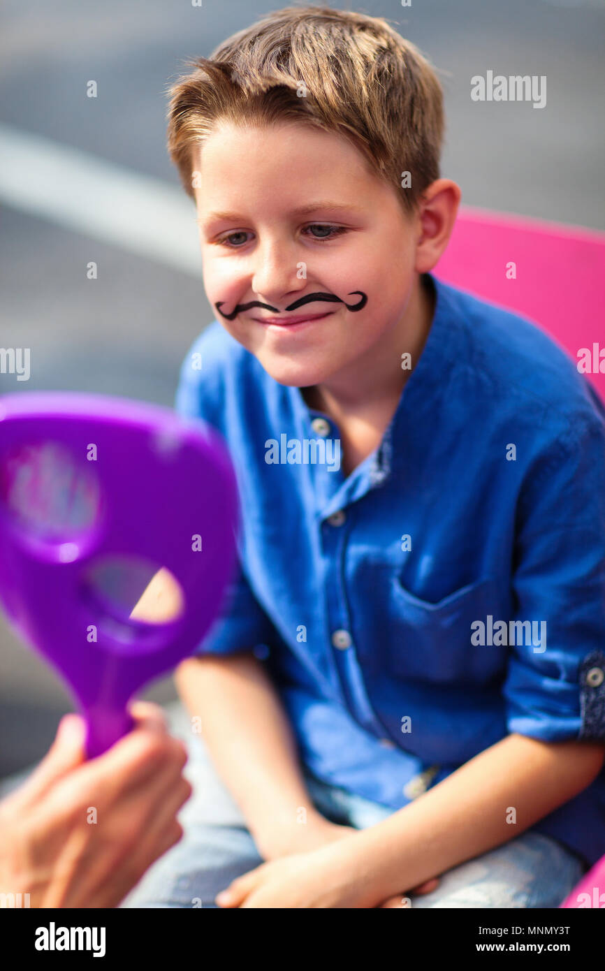 Portrait of a cute little boy with mustache painted on his face Stock ...