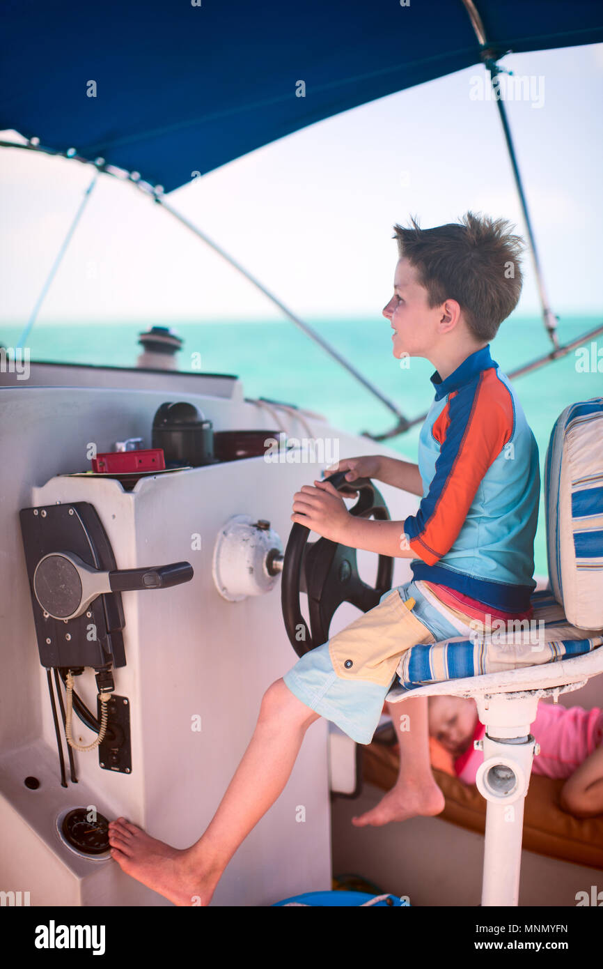 Cute little boy at sail boat wheel Stock Photo - Alamy