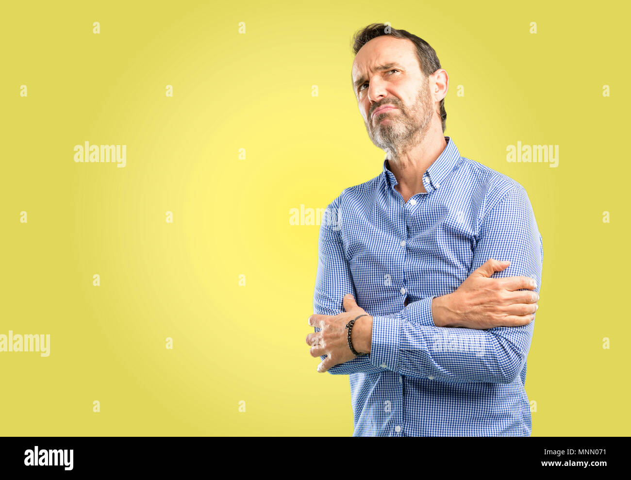 Handsome middle age man irritated and angry expressing negative emotion ...