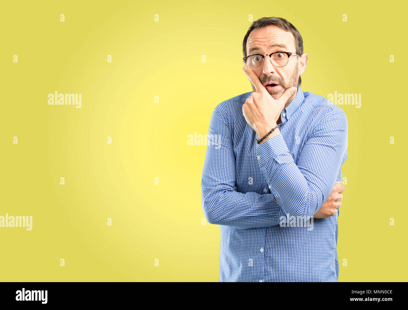 Handsome middle age man scared in shock, expressing panic and fear ...