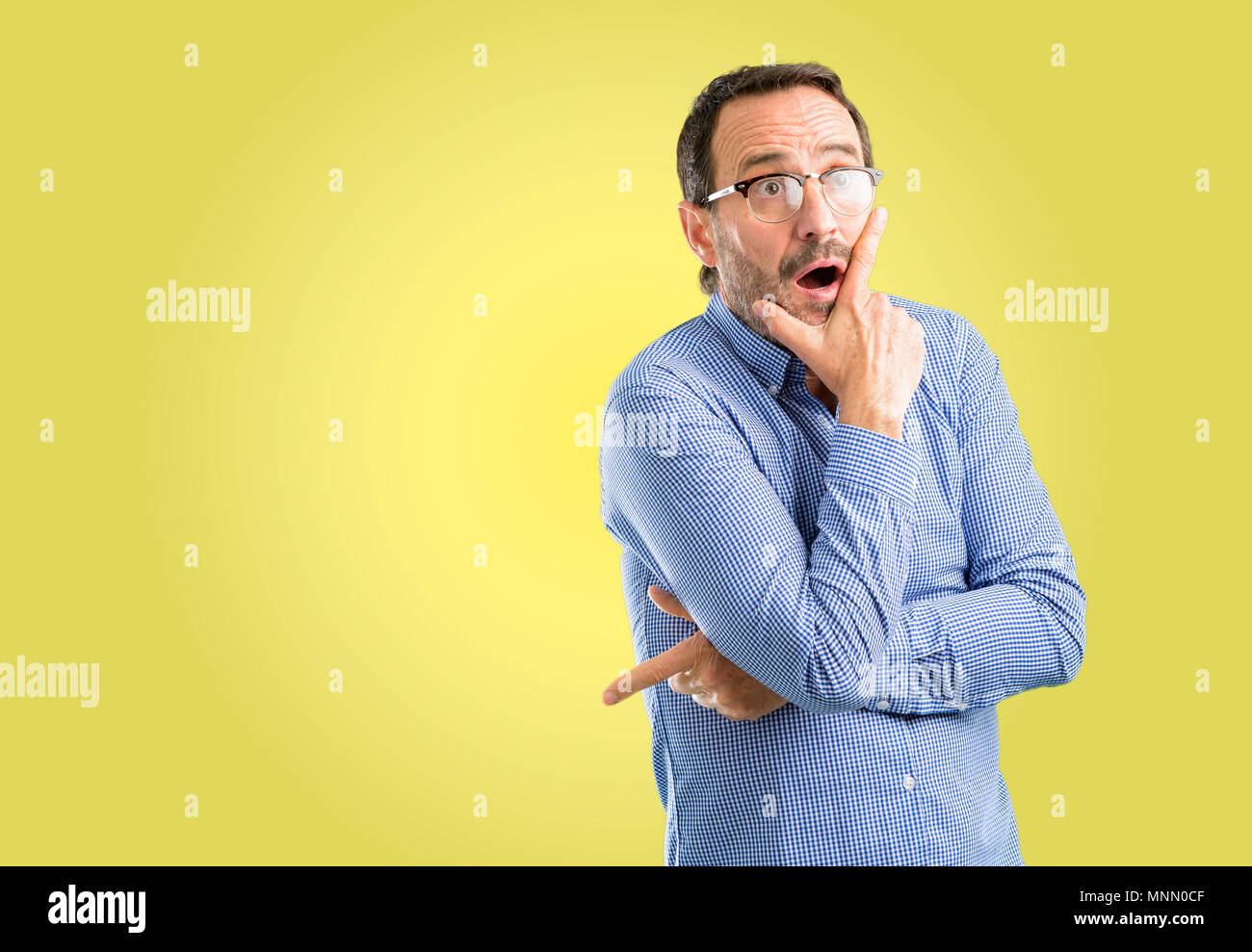 Handsome middle age man scared in shock, expressing panic and fear ...