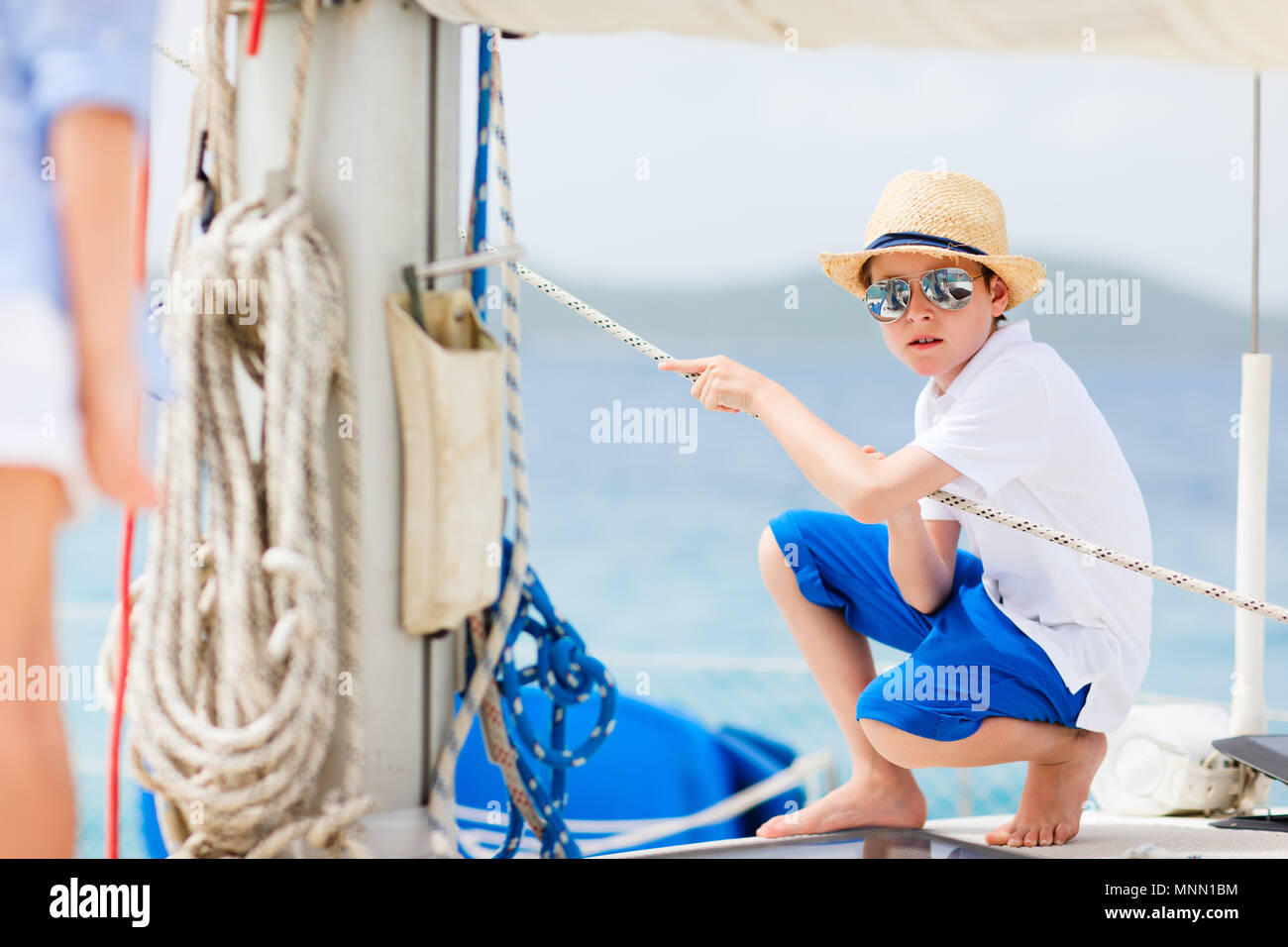 Cute teenage boy enjoying sailing on a luxury catamaran or yacht Stock ...
