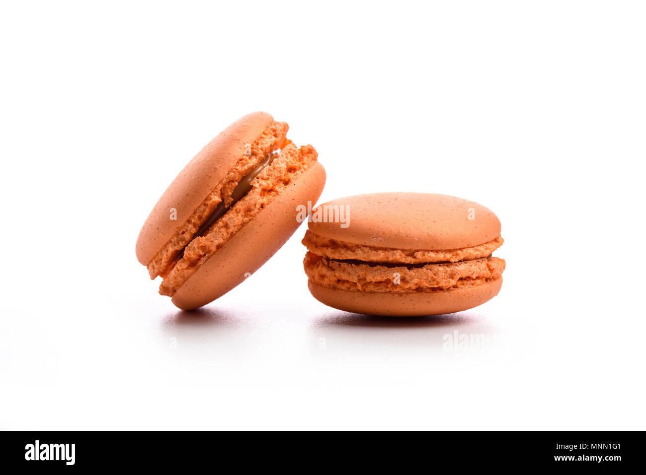 Orange macaroons isolated on white background. Close up Stock Photo - Alamy