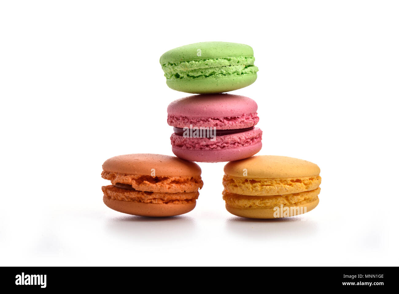Green, pink, orange and yellow macaroons isolated on white background ...