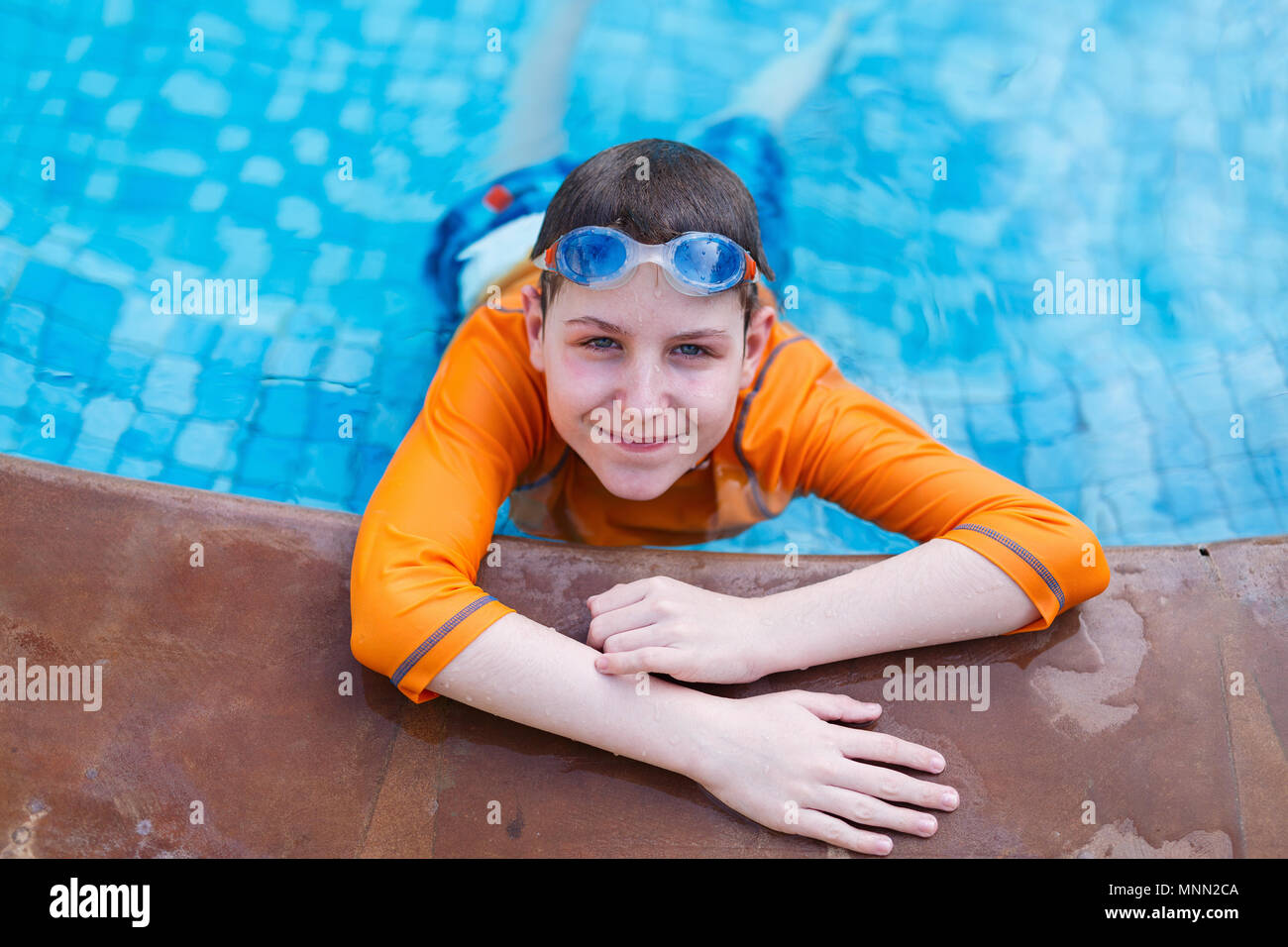 Cute boy wearing sun protection swimwear at pool Stock Photo - Alamy