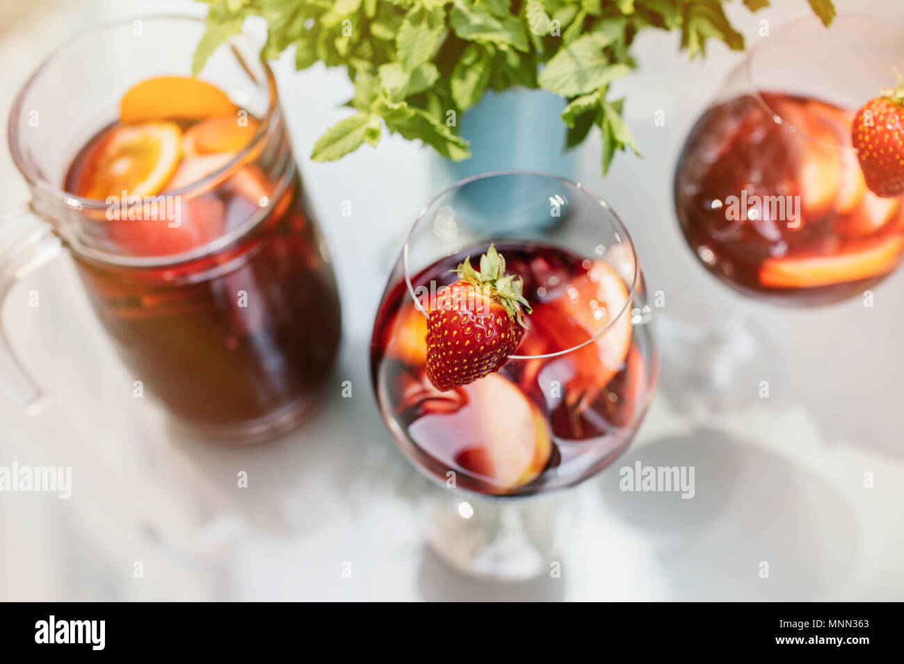 Top view of summer dinks, fruit cocktails on white wood table with ...