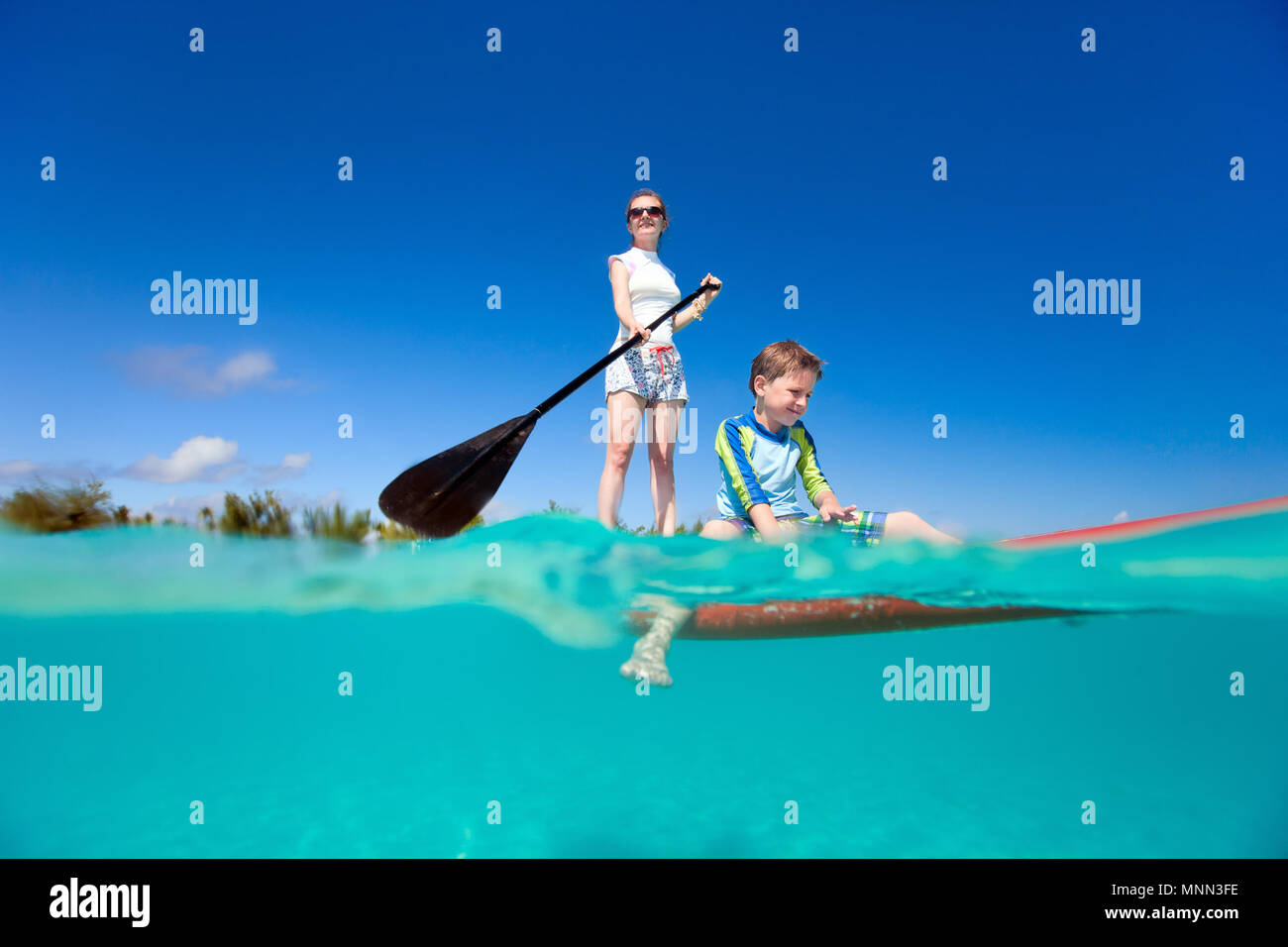 Mother and son paddling on stand up paddle board Stock Photo - Alamy