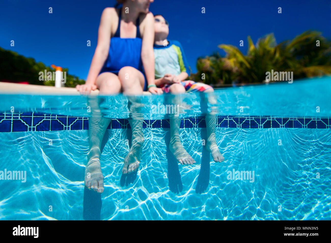 Split above and underwater photo of mother and son relaxing near a ...
