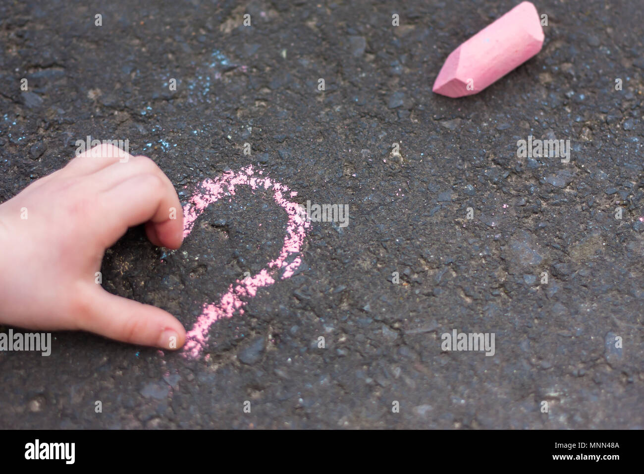 Child hand shows heart sign on chalk drawing Stock Photo - Alamy