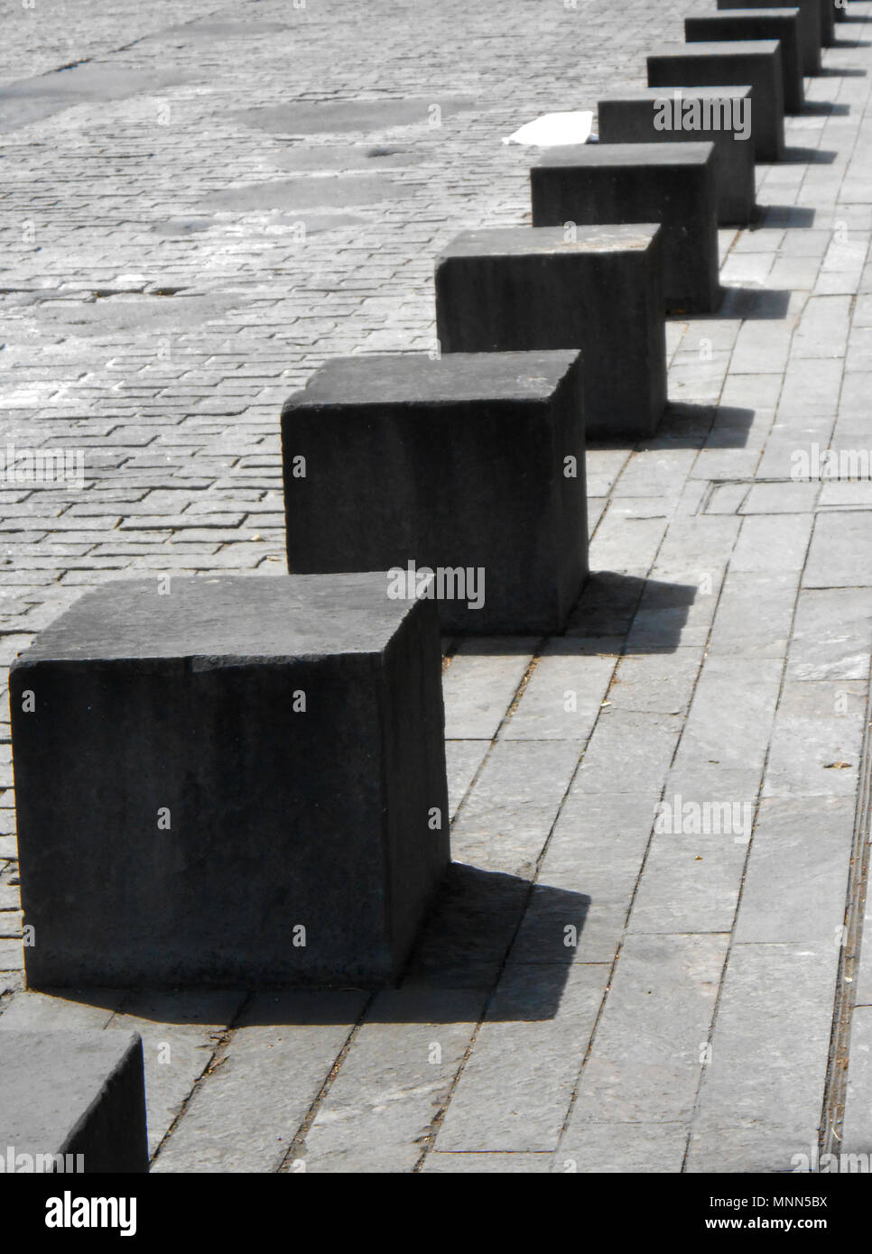 A row of concrete blocks going back to a vanishing point on a ...