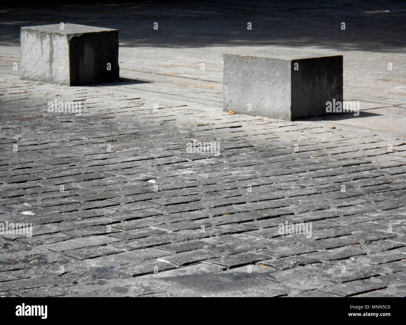 Two concrete blocks on a cobblestone street in France Stock Photo - Alamy