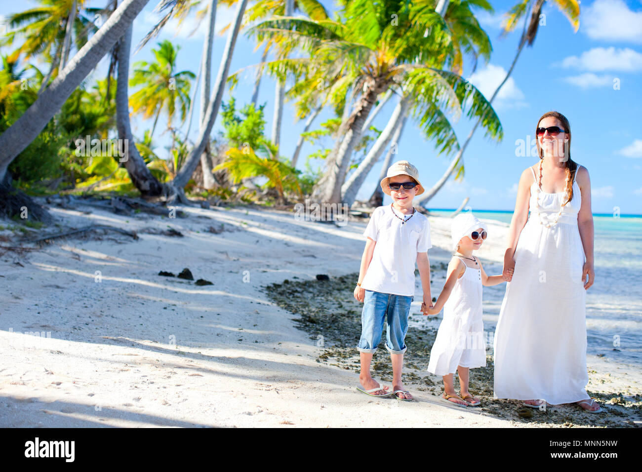 Beautiful family of mother and two kids on a deserted island Stock ...