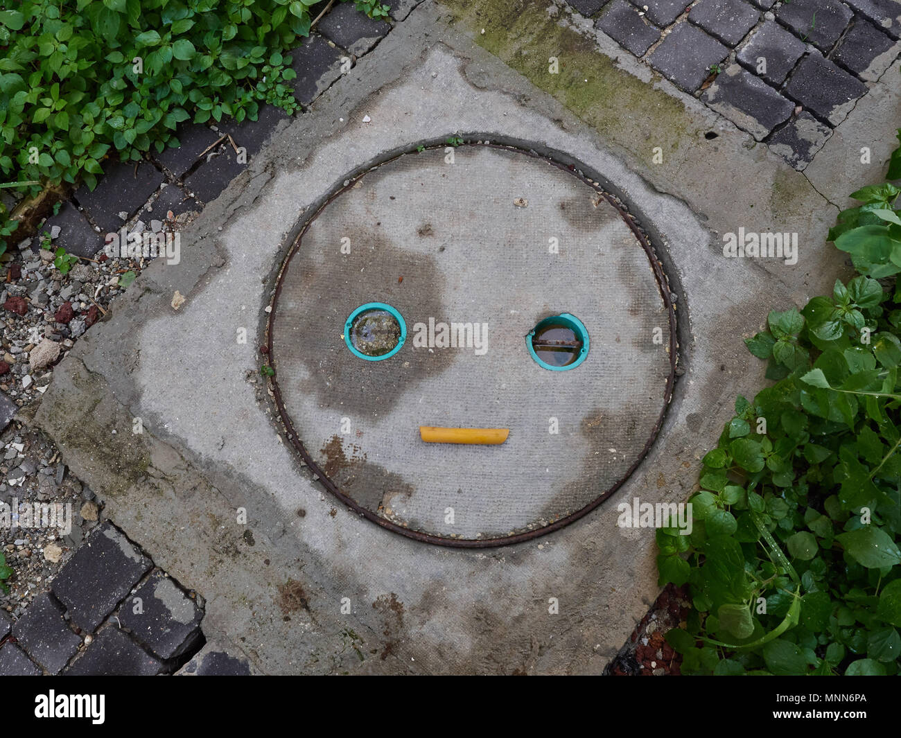 Abstract painting, round sewer hatch, depicting a human face Stock ...