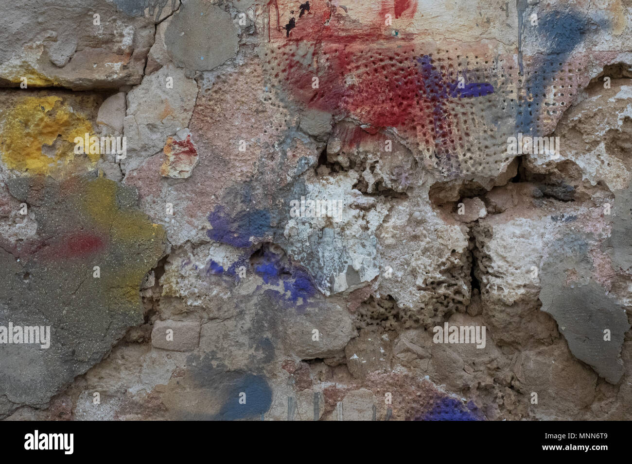 Abstract grunge background of an old half-ruined stone wall, with spots ...