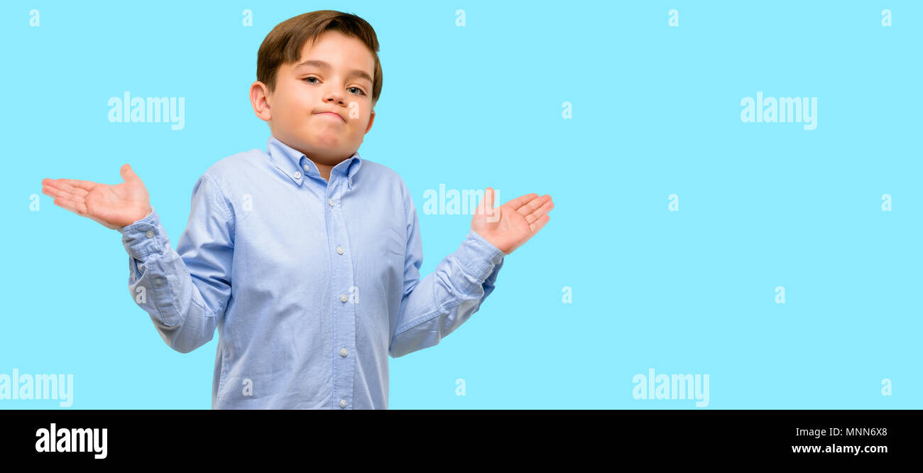 Handsome toddler child with green eyes doubt expression, confuse and ...