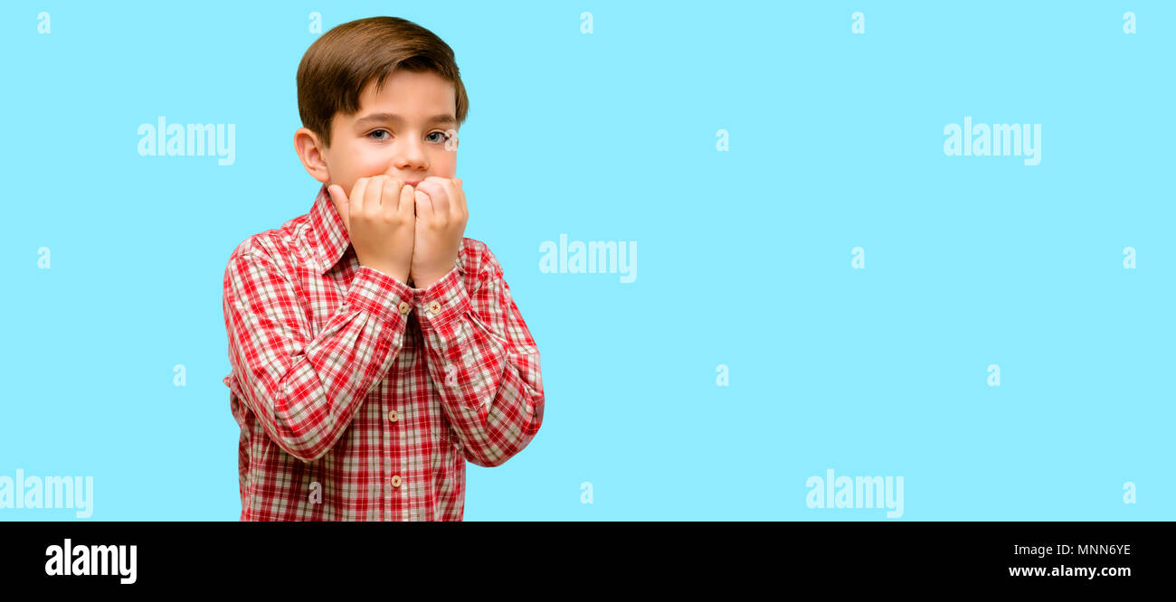 Handsome toddler child with green eyes terrified and nervous expressing ...