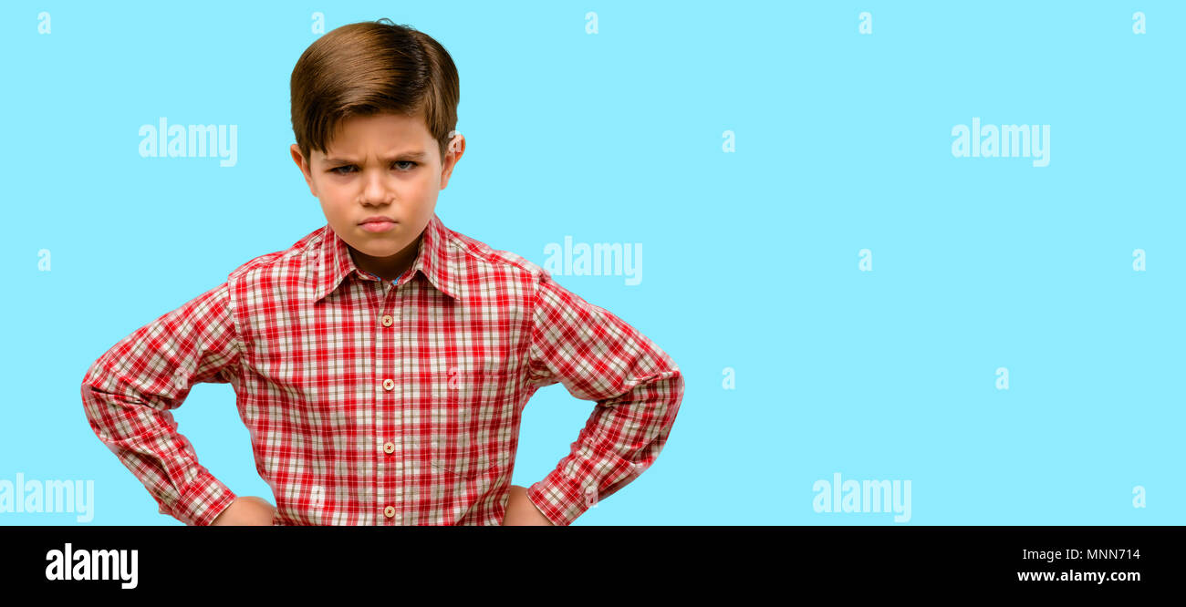 Handsome toddler child with green eyes irritated and angry expressing ...