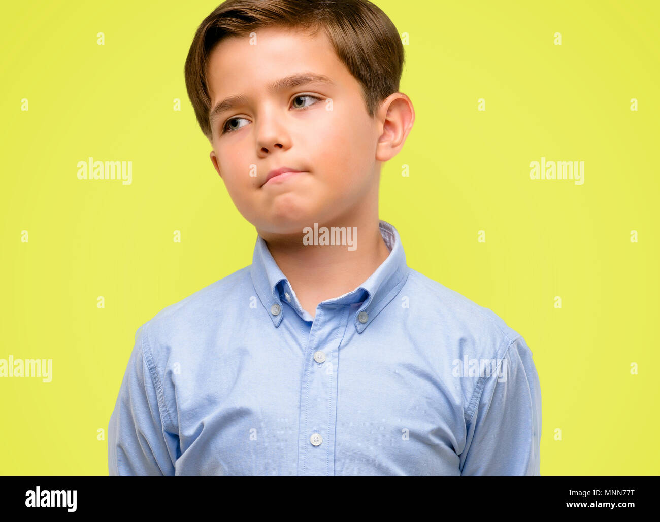 Handsome toddler child with green eyes doubt expression, confuse and ...