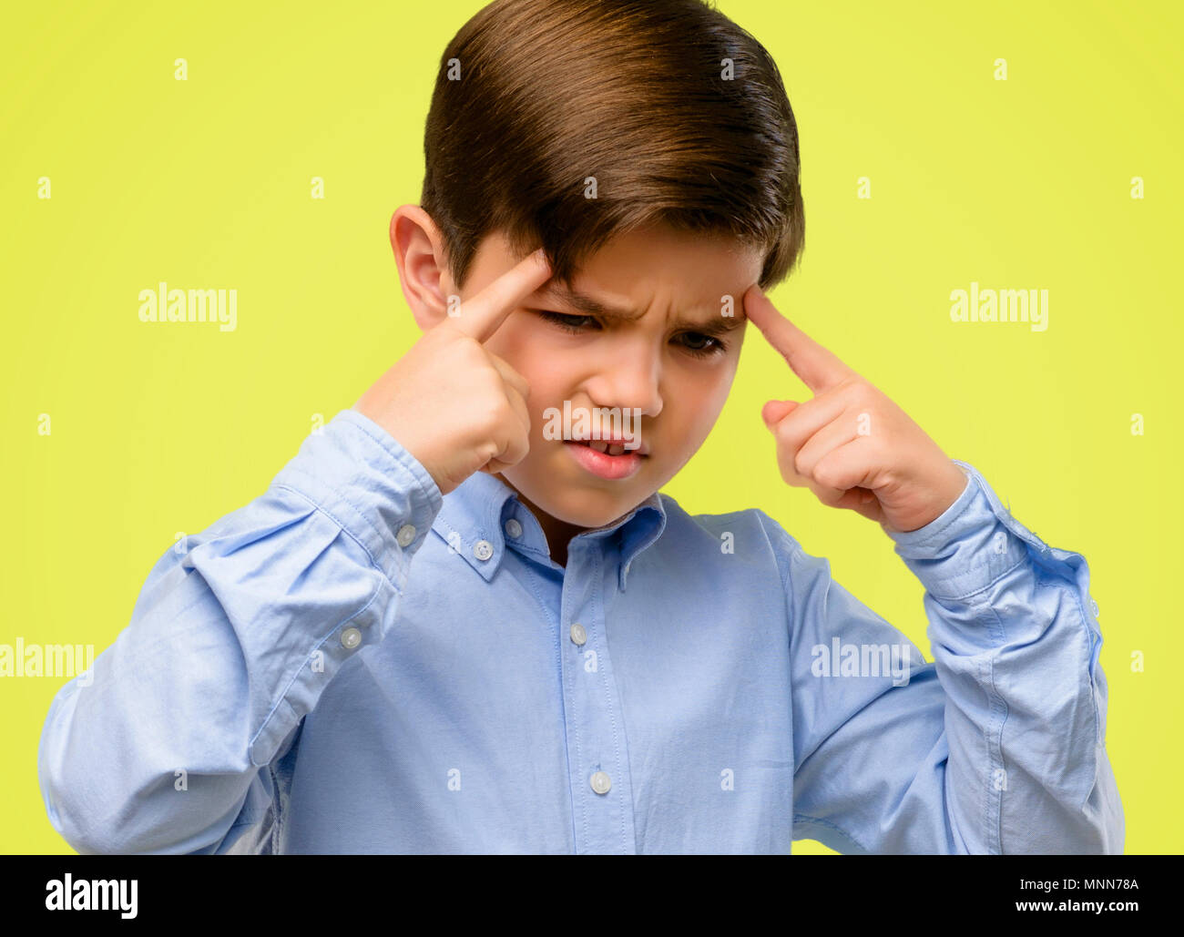 Handsome toddler child with green eyes doubt expression, confuse and ...
