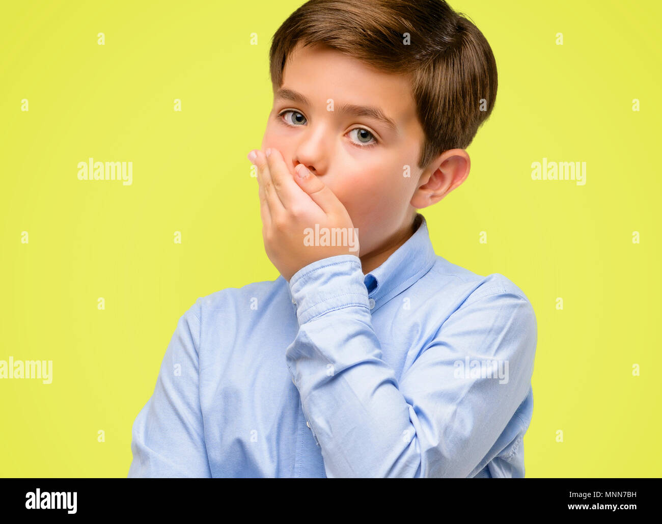 Handsome toddler child with green eyes scared in shock, expressing ...